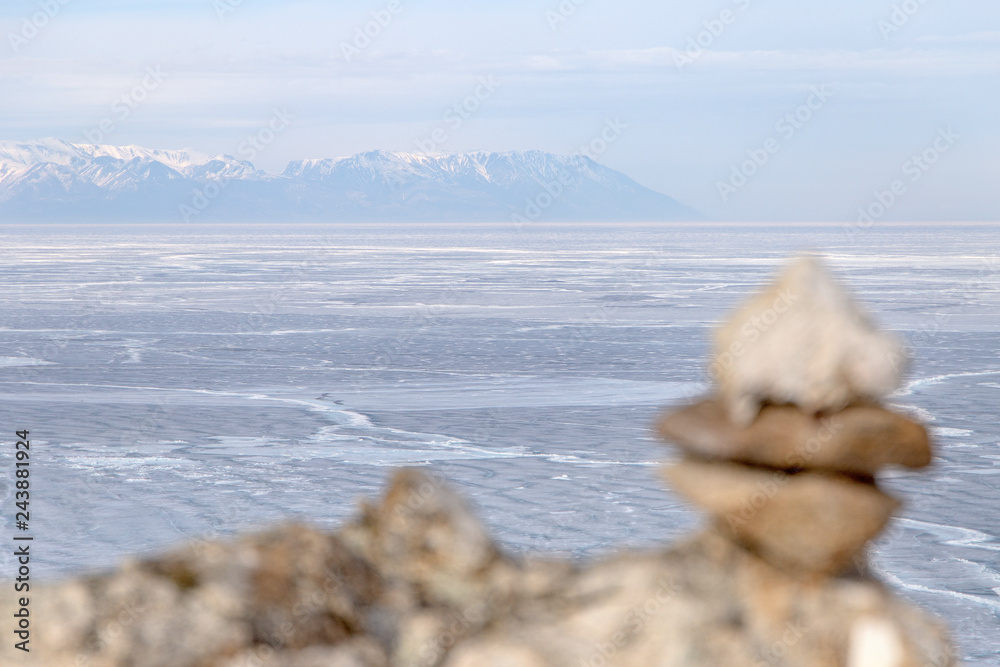 Stone pyramids for spirits on Olhon island. Baikal lake winter ...