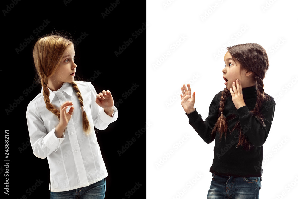 The portrait of two frightened, afraid, scared girls on a white and ...