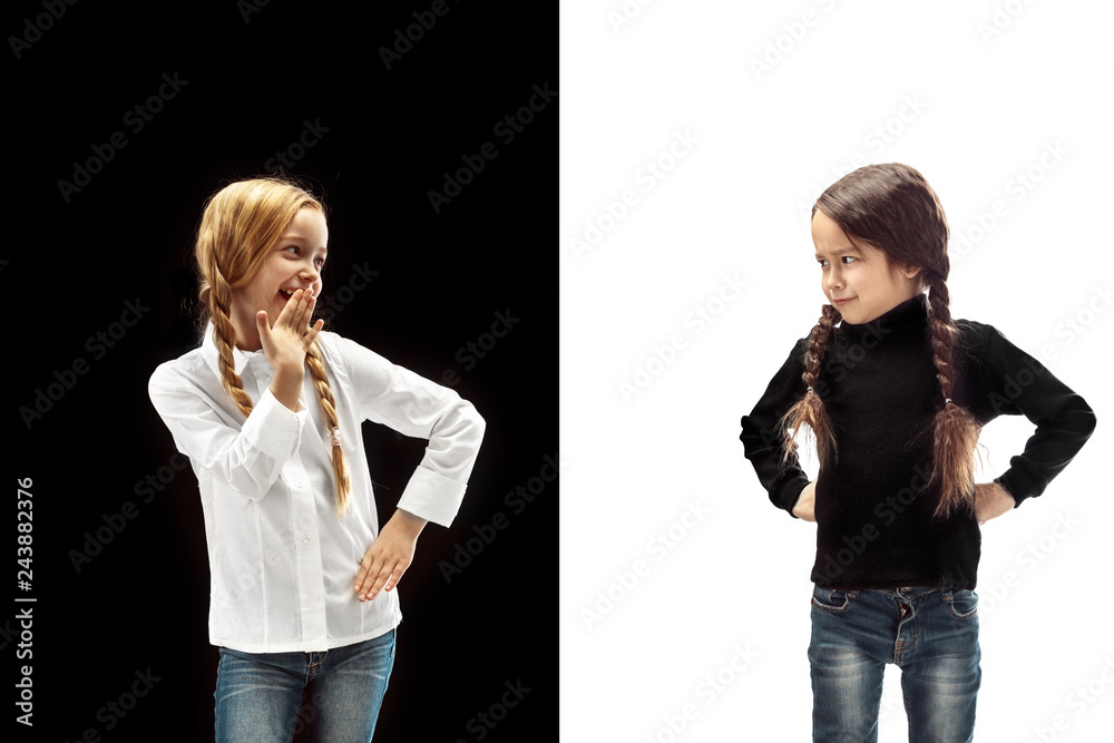 The portrait of emotional happy winner girl and serious angry girl on a ...