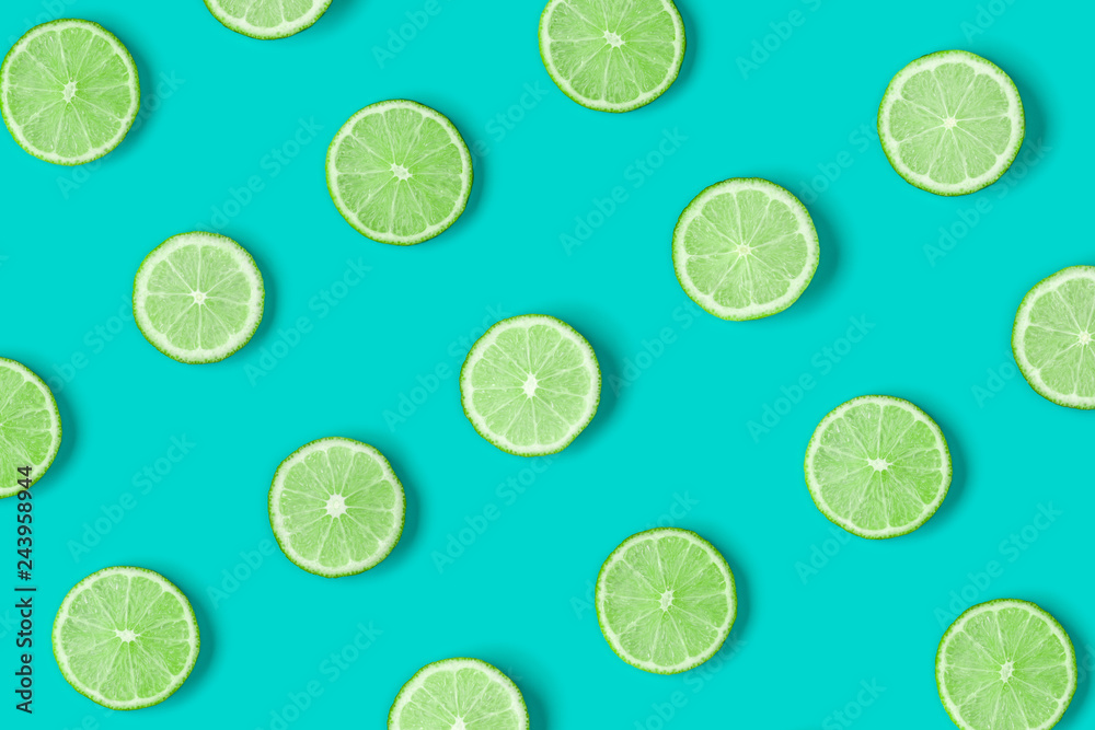 Fruit pattern of lime slices on blue background. Flat lay, top view ...