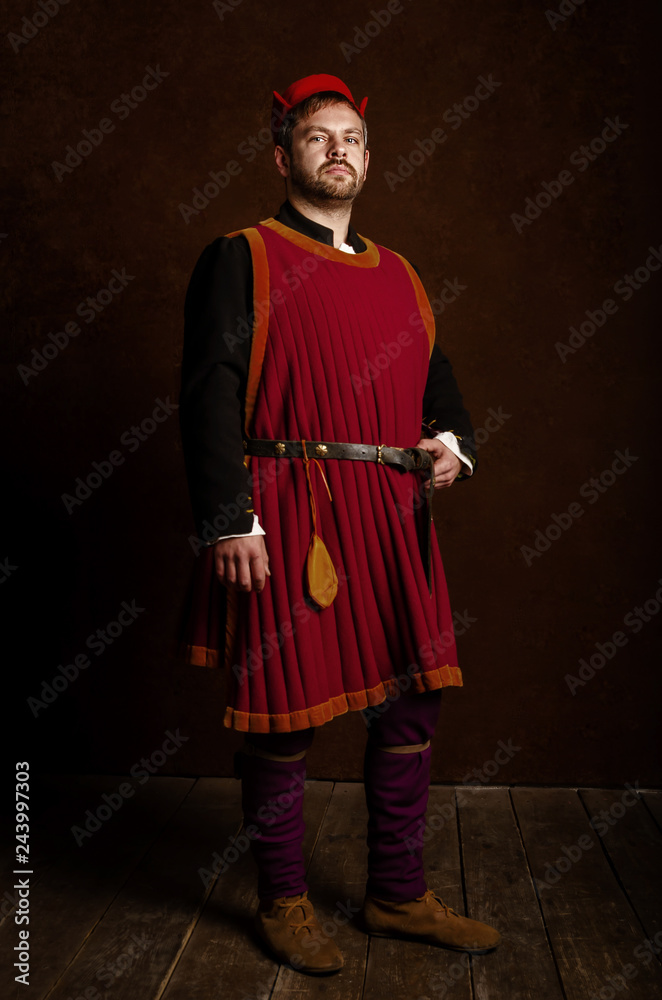 man (actor) in a 15th century costume (medieval) on an aged stylized ...
