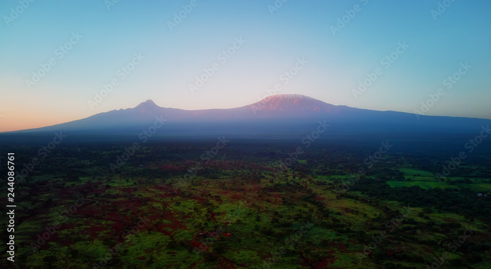 Aerial, panoramic view on Mount Kilimanjaro volcano, summit covered in ...