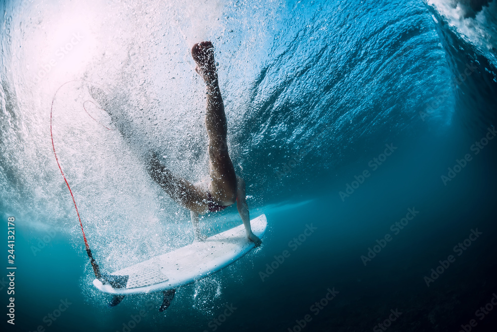 Surfer woman dive underwater with under wave. Stock Photo | Adobe Stock