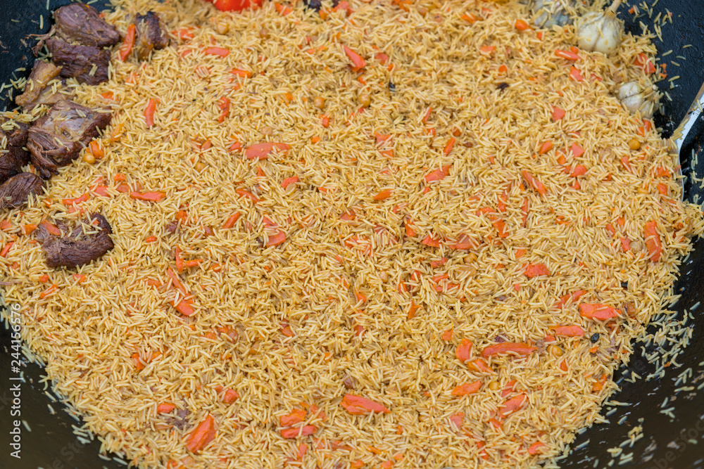 Uzbek pilaf in the market. Picnic with uzbek pilaf. Oriental pilaf ...