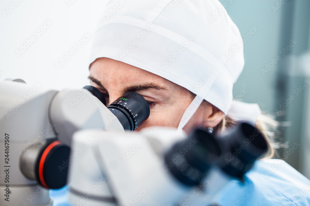 Doctor using microscope during eye surgery process, treatment of ...