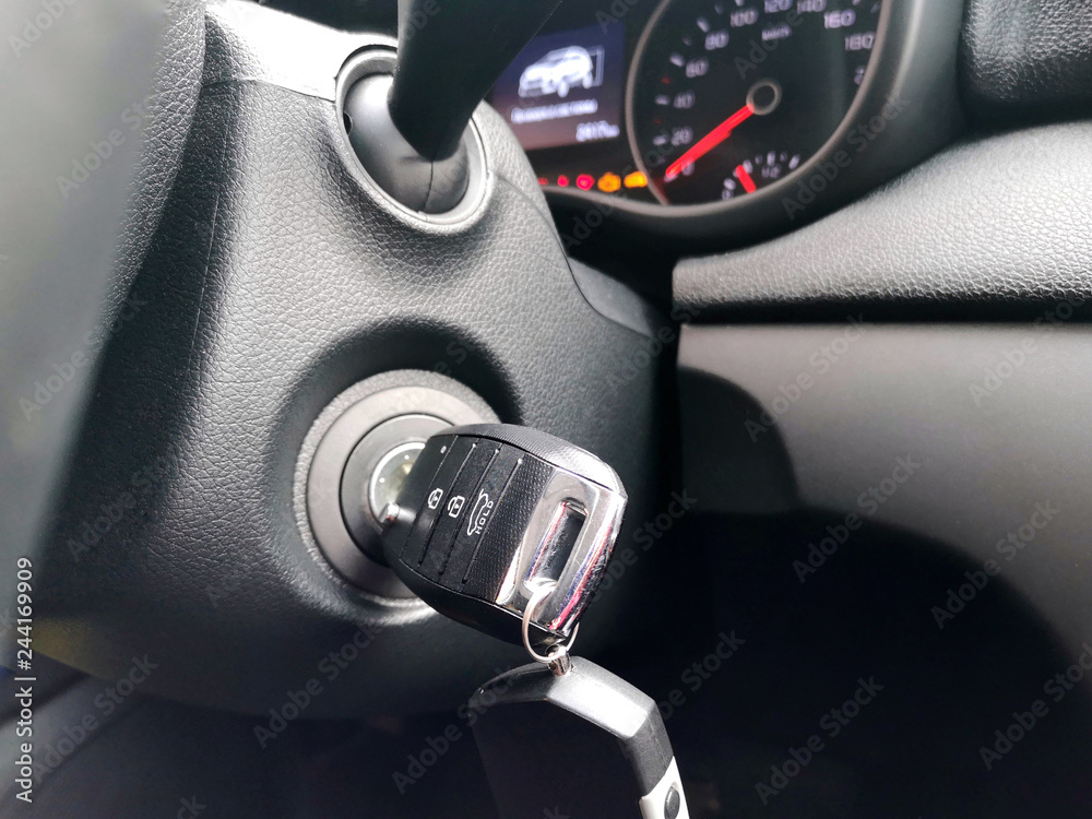 Car key and black dashboard with selective focus. Modern digital car ...