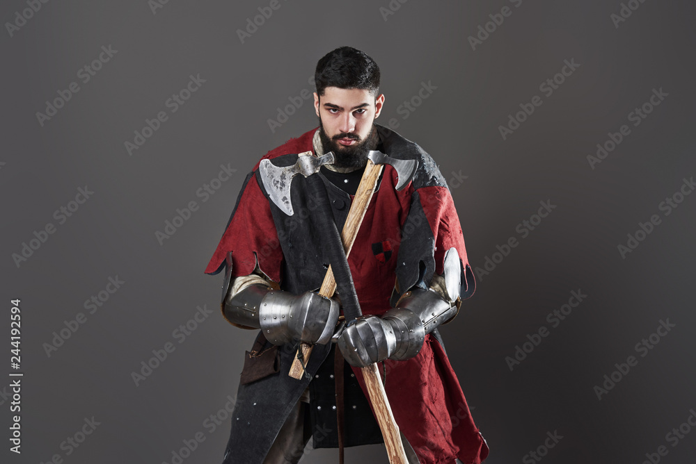 Medieval knight on grey background. Portrait of brutal dirty face ...