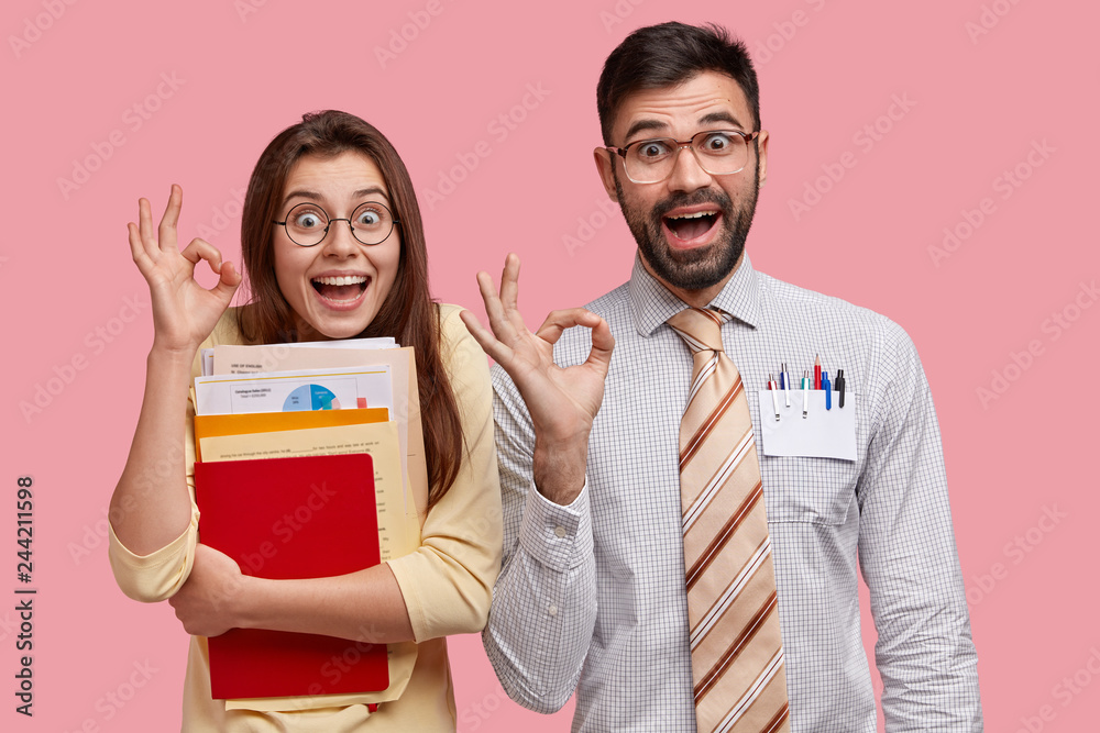 Satisfied female and male show okay gesture, demonstrate everything is ...