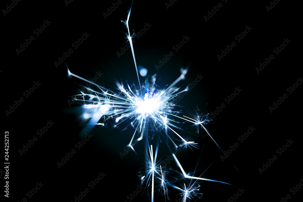 Low light photo of bengali fire isolated on black background with blue ...