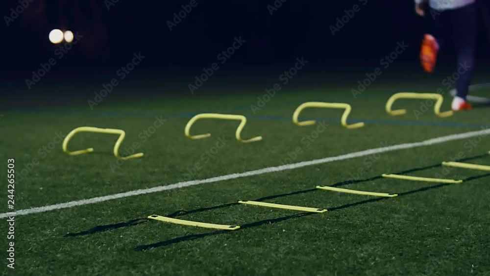 Soccer agility training equipment. Professional football player with ...