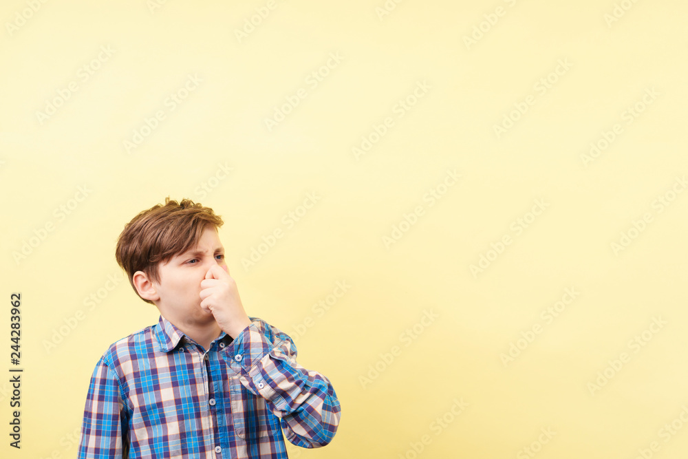 bad smell, stink, squeamishness, repulsion. boy with disgusted face ...