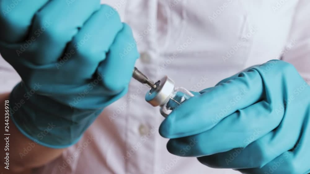 The nurse pierces the rubber stopper of the ampoule with a syringe ...