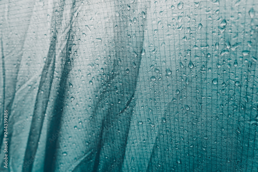 Green fabric with water drops as background. Water drops on tent awning ...