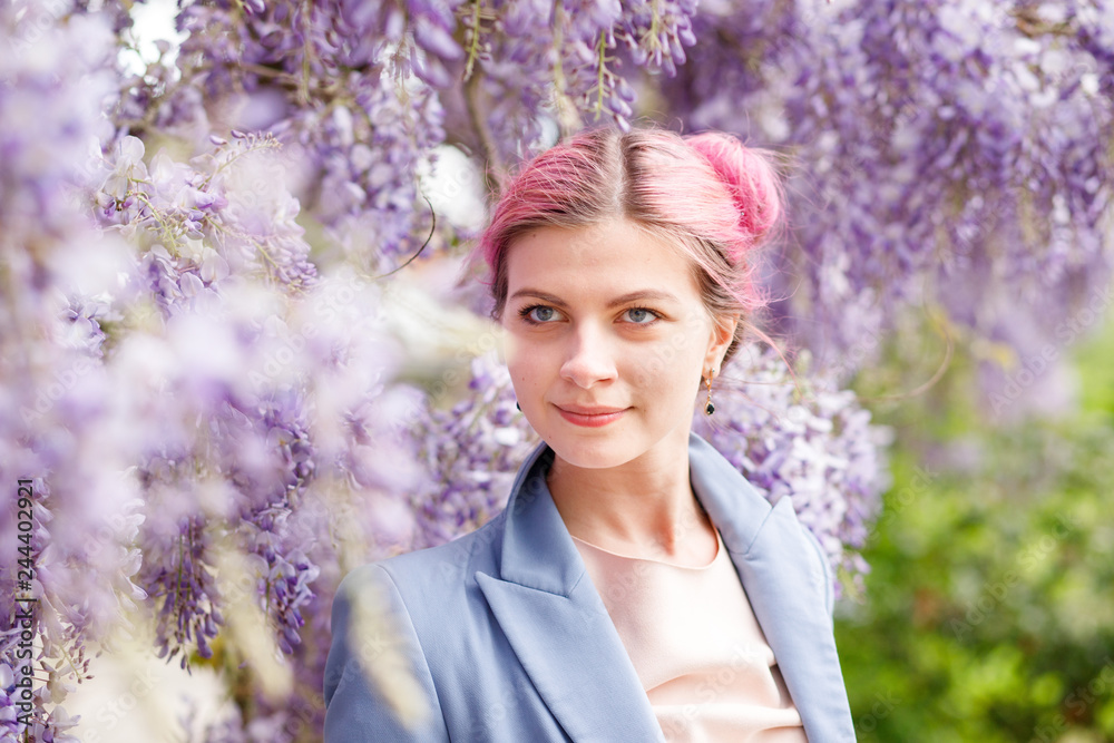 Gentle refined woman in the garden of wisteria trees. Stock Photo ...