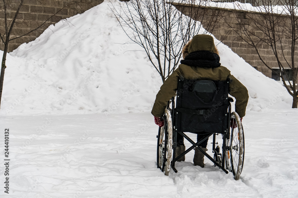 Disabled handicapped man has a hope. He sits in a wheelchair and looks ...