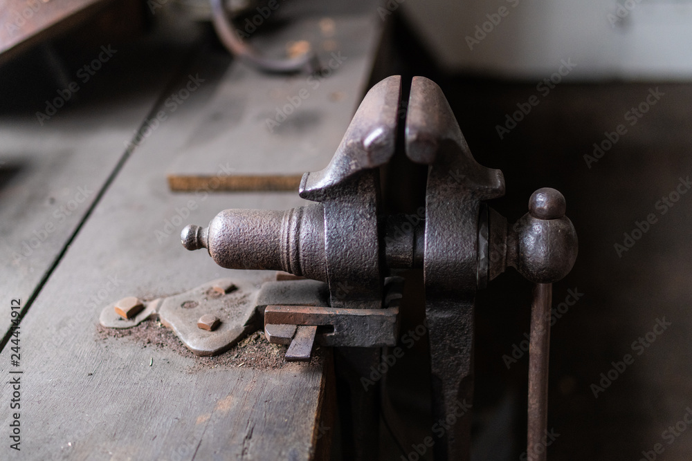 Vintage tools on a bench lit by a window, vice, gunsmith, gun, smith ...