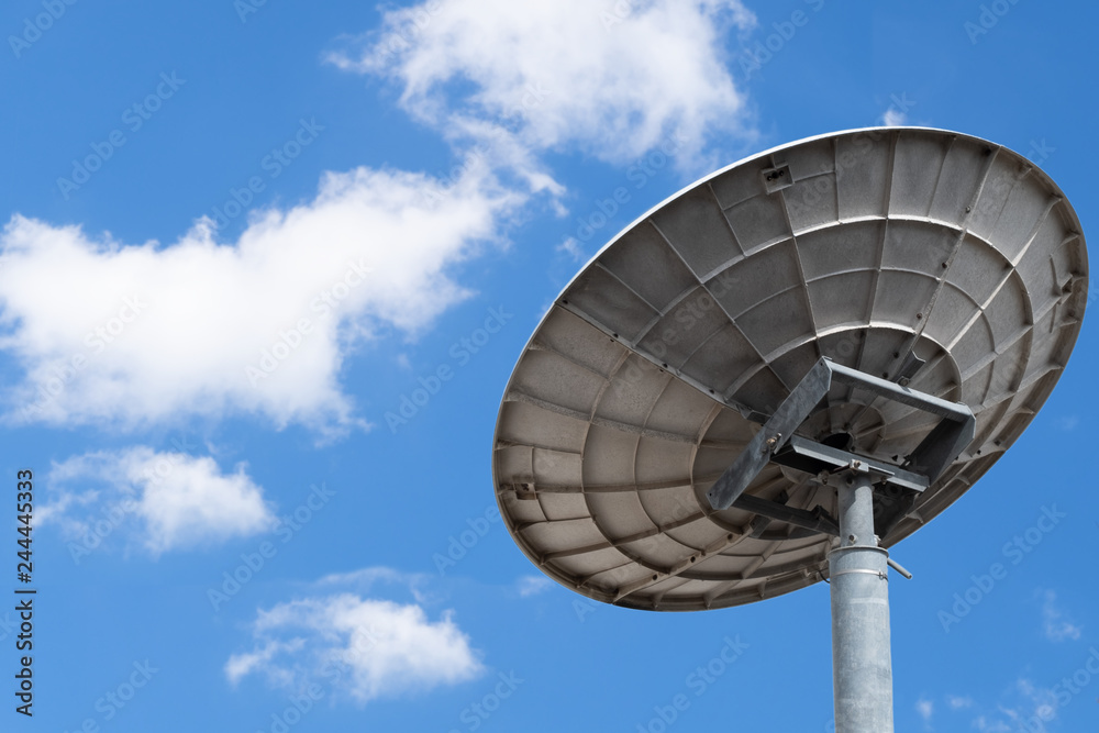 communication satellite dish on bright and blue sky background ...