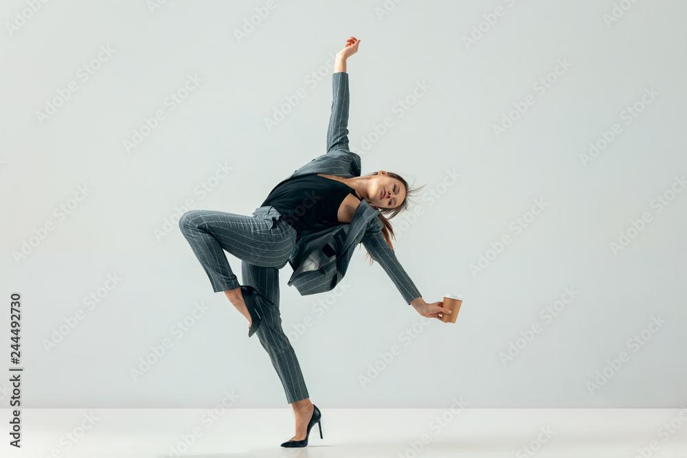 Happy business woman dancing and smiling in motion isolated over white ...