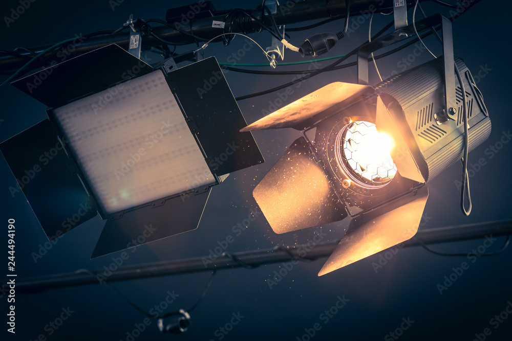 Professional orange studio spotlight in a TV studio. Lighted dust ...