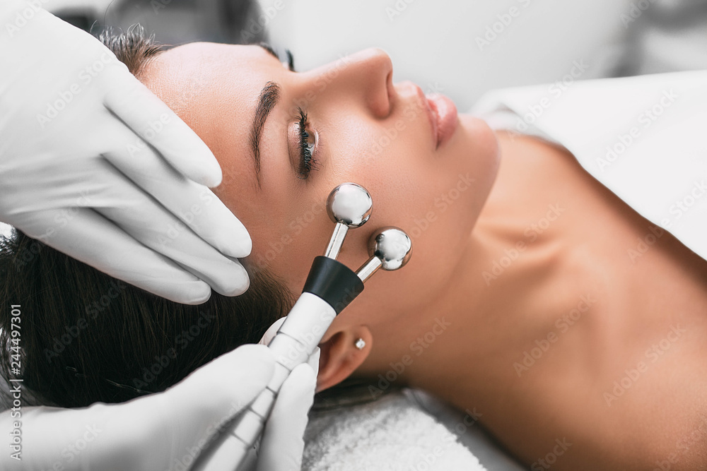 Beautiful woman receiving facial microcurrent procedure for lifting ...