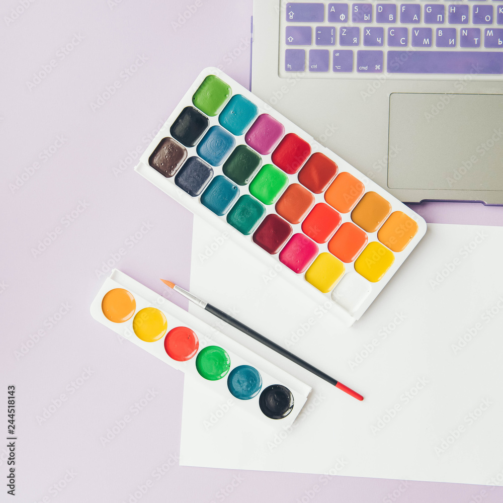 Workspace of painter with watercolor paints and brush in home office ...