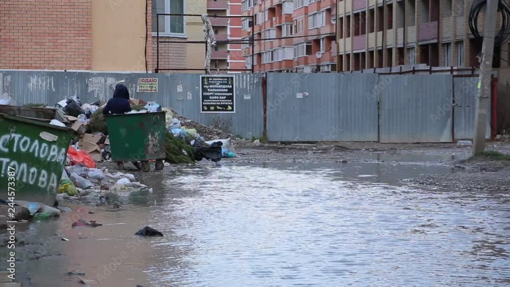 Terrible view of garbage dump in residential yard and huge dirty puddle ...