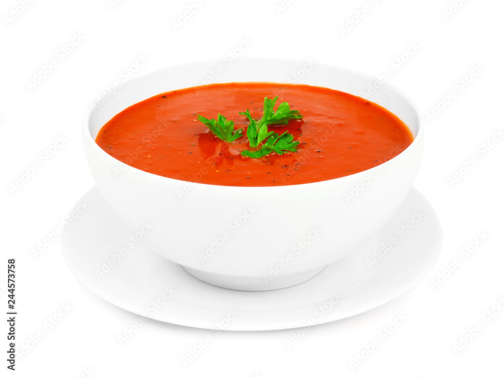Homemade tomato soup in a white bowl with saucer. Side view isolated on ...