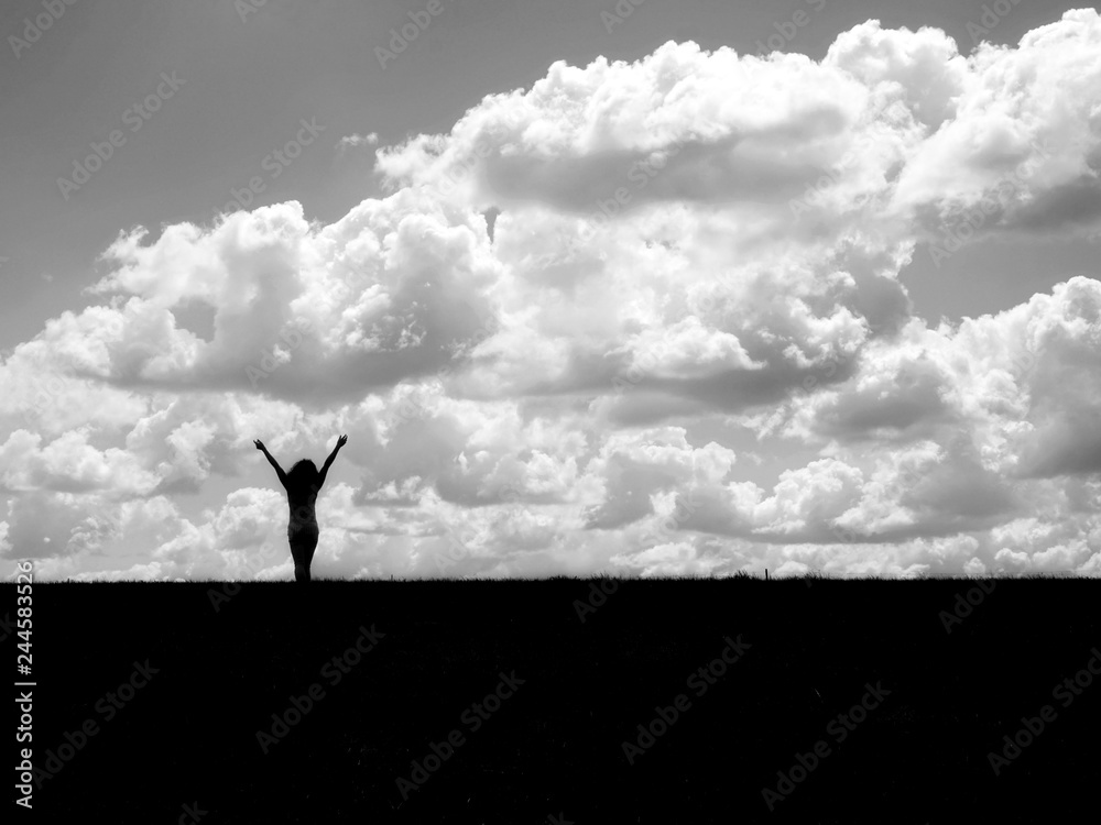 Silhouette of a girl with arms up. High contrast black and white ...