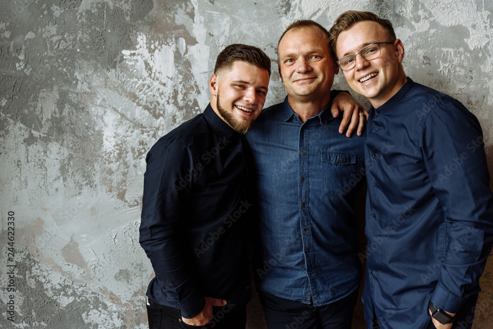 Dad and his young sons. Two adult sons are standing with their beloved ...