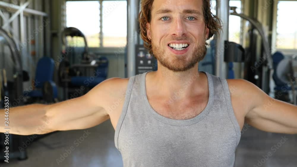 Fitness man at gym doing butterfly chest workout on fitness machine at ...