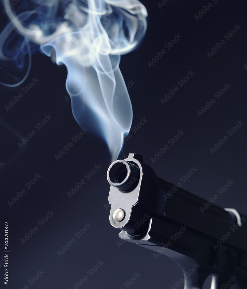 Smoking gun on dark background Stock Photo | Adobe Stock