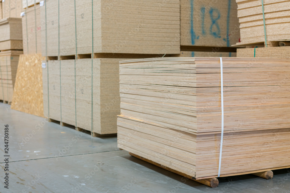 timber in warehouse. Pallet with boards in the hardware store. Packed ...