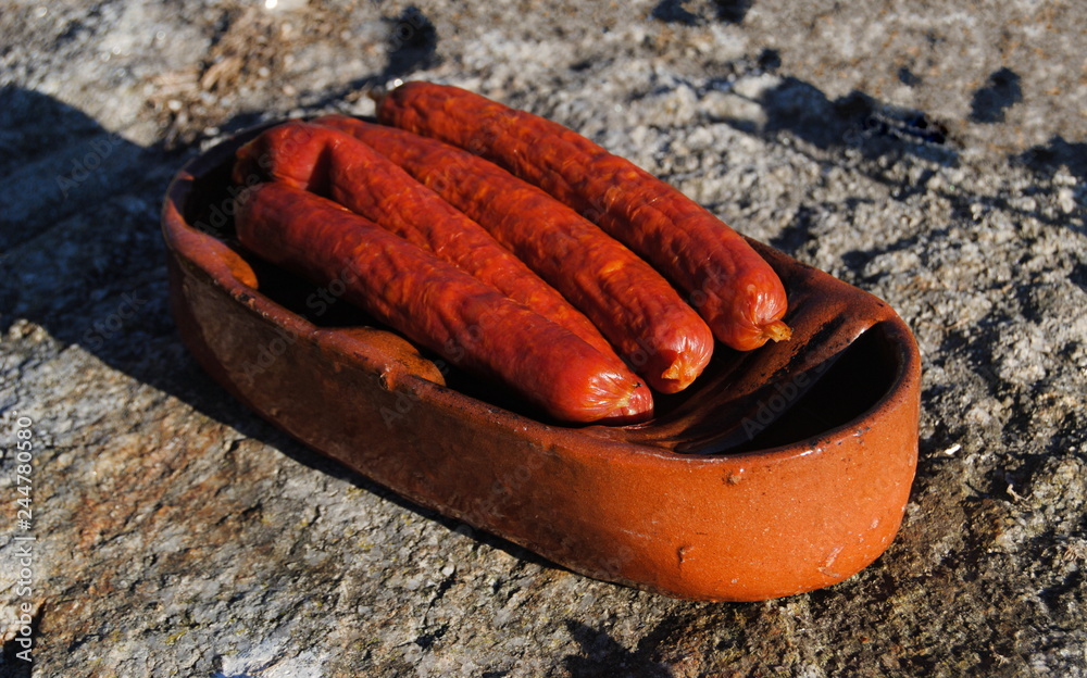 Mergueses numa travessa de barro prontas para assar, lanche tradicional ...