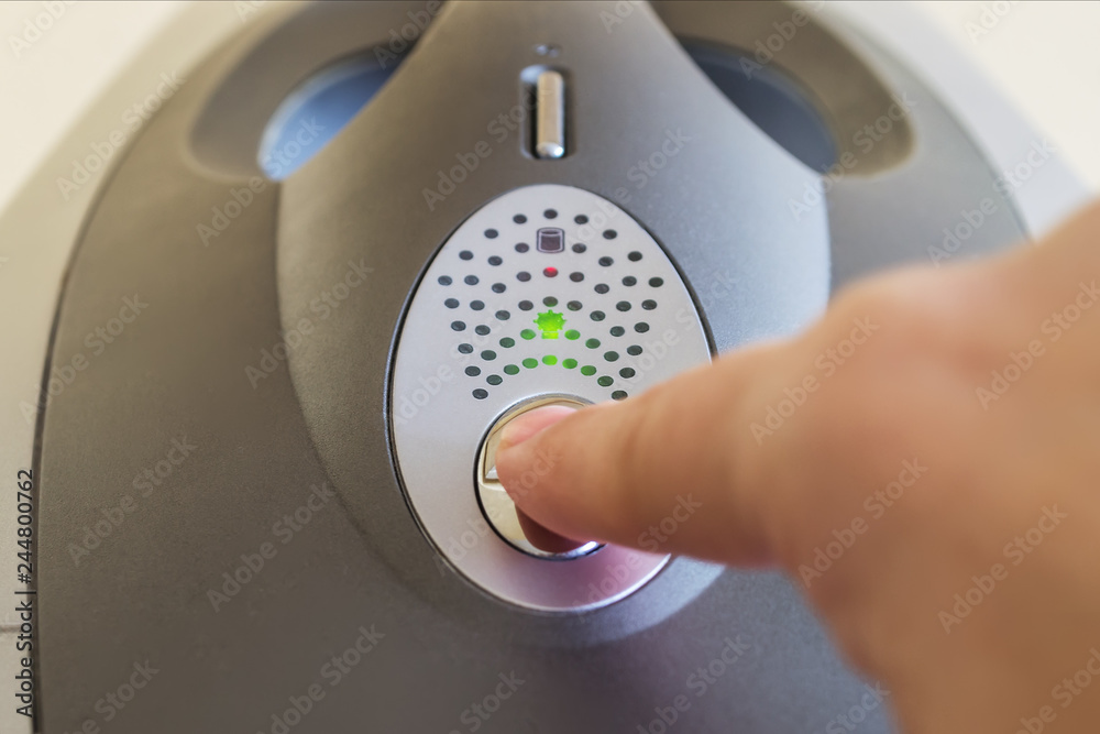 Finger is ready to push on Off button on the top of the personal ...