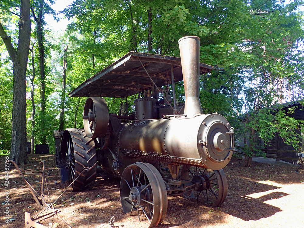 An old copper colored turn of the 19th century steam engine ...