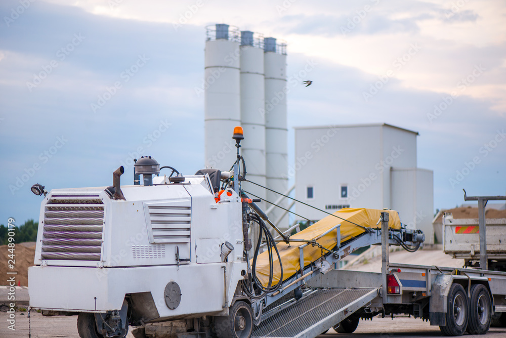 Cold milling machine being transported. Transportation trucks and ...