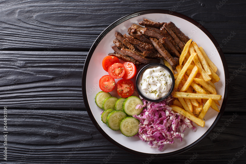 Freshly cooked shawarma plate with beef, french fries, vegetables and ...