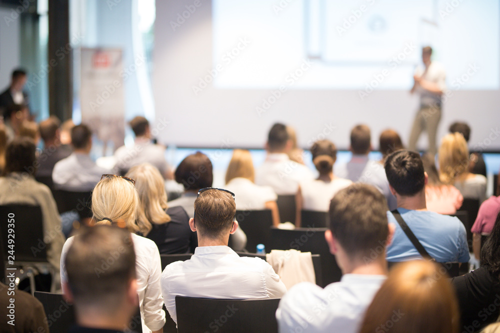 Speaker giving a talk in conference hall at business event. Audience at ...