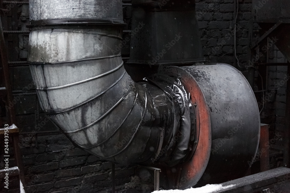 Cropped smoked metal pipe with a turbine to exhaust air from thermal ...