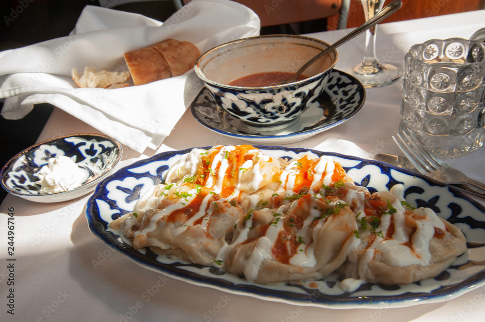 Manti: traditional Russian dumplings with a bowl of borscht (beet soup ...