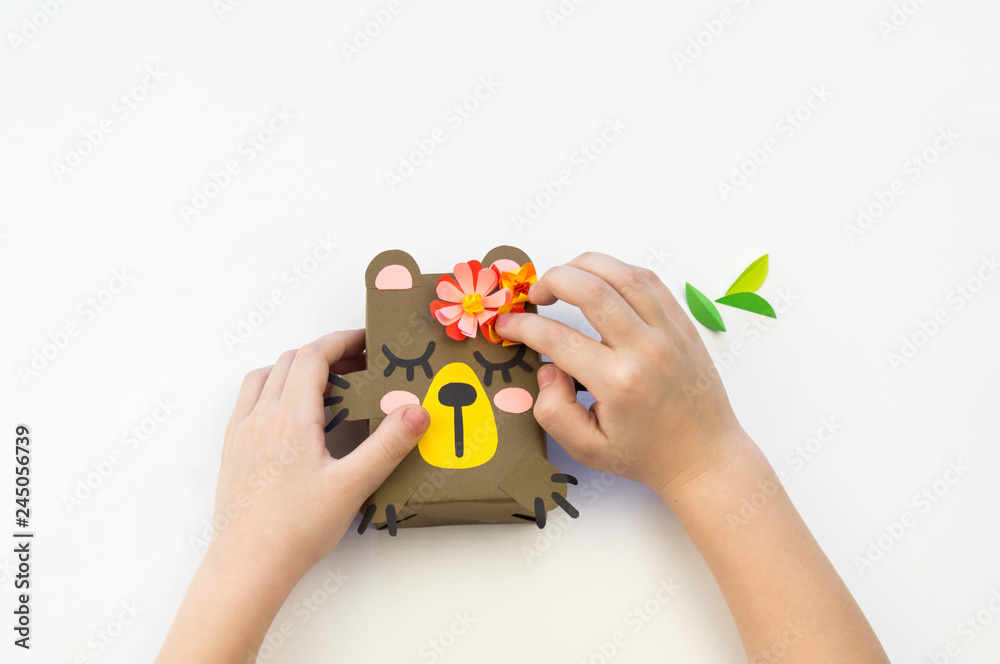 Child making gift a bear box. Teddy bear out of paper craft. Packaging ...