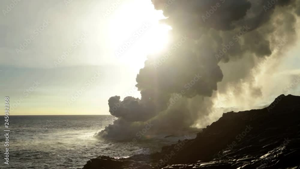 Volcanic molten lava pouring from a fissure into the Pacific ocean ...