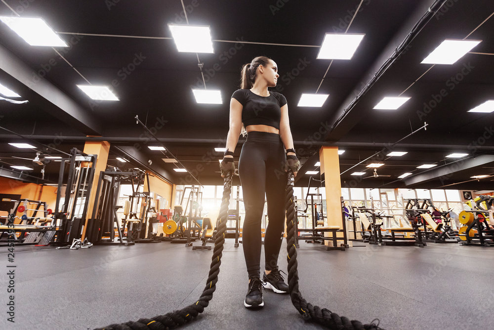 Portrait of a beautiful positive hardy young female crossfit engaged ...