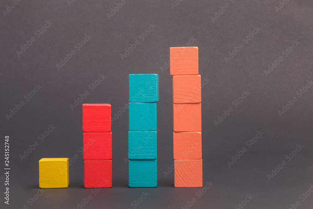 Toy wooden blocks as financial graph. Graph with four 4 steps. Growing ...