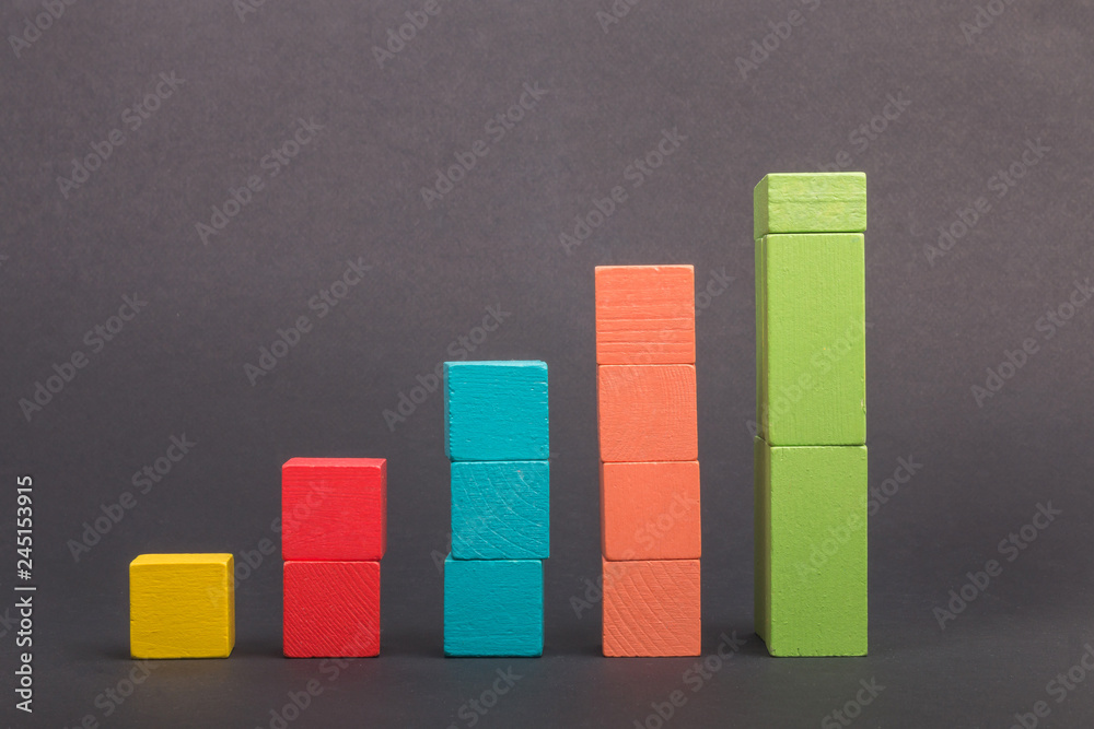 Toy wooden blocks as financial graph. Graph with four 4 steps. Growing ...