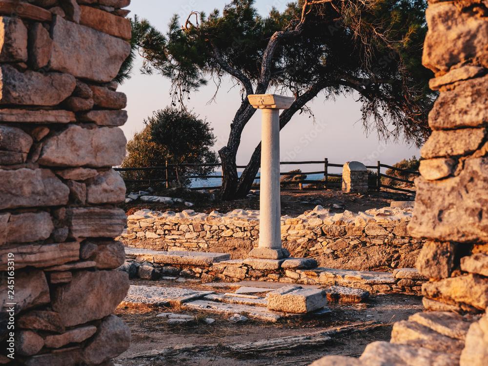 Old stone column in the ruins of the ancient Aliki stone quarry and ...