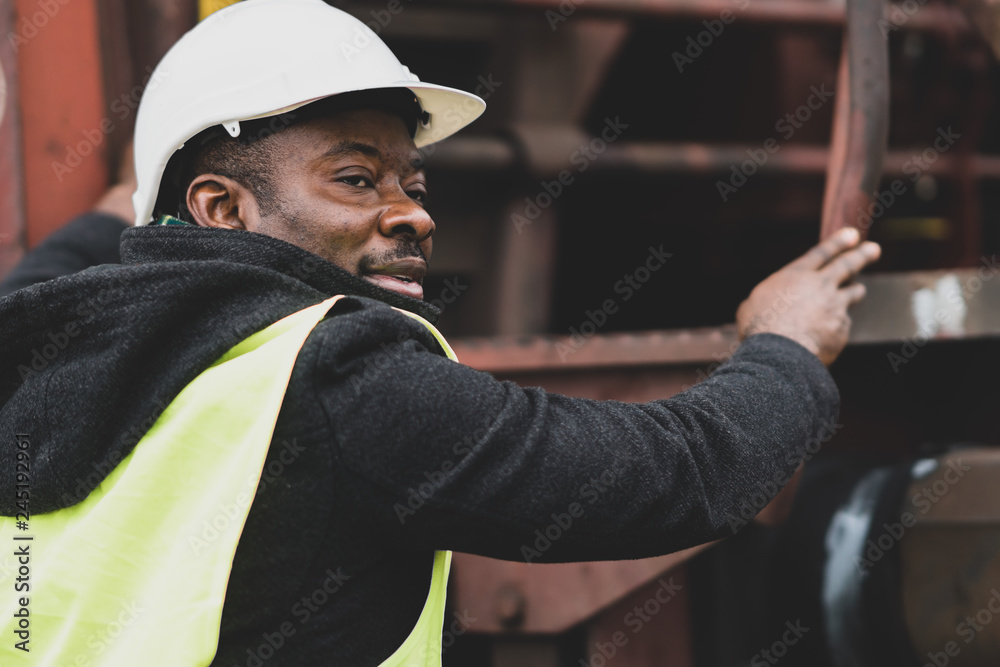 African American railroad engineer wearing safety equipment (helmet and ...
