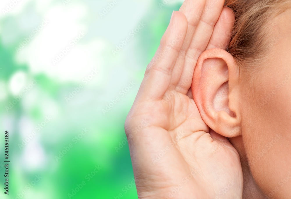 Girl listening with her hand on an ear cose up Stock Photo | Adobe Stock