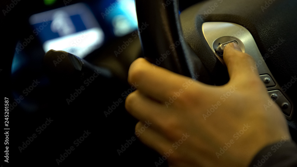 Driver hand pressing source button on steering wheel, testing modern ...