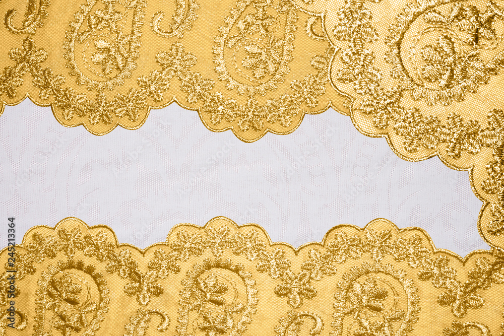 Gold lace on white fabric.Background with gold patterns. Stock Photo ...